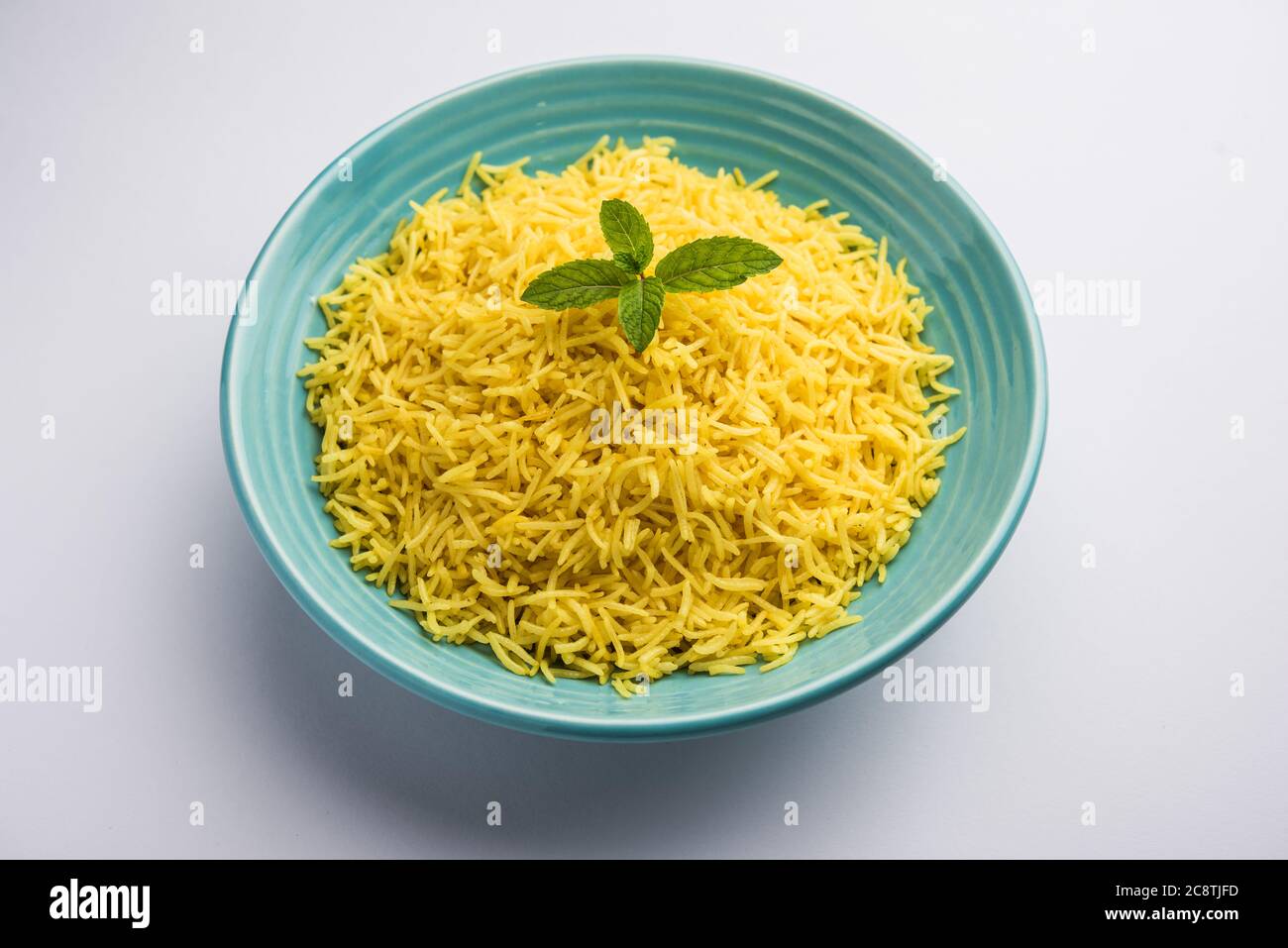 Cooked turmeric jasmine rice with powdered curcumin or Haldi, Indian ...