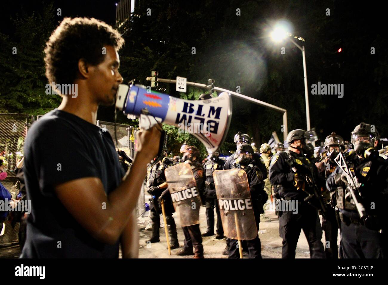 Portland, Oregon, USA. 26th July, 2020. A man on a BLM bullhorn ...