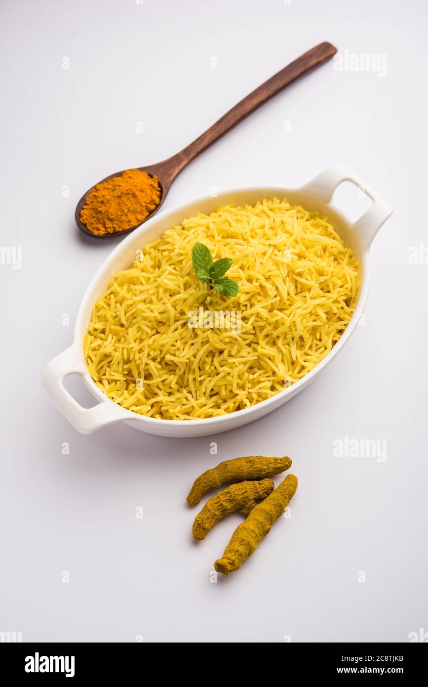 Cooked turmeric jasmine rice with powdered curcumin or Haldi, Indian ...
