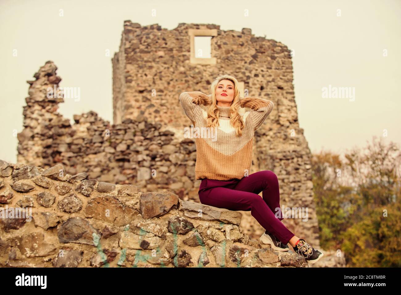 Woman makeup face sit on stony ruins background defocused. Tourism ...
