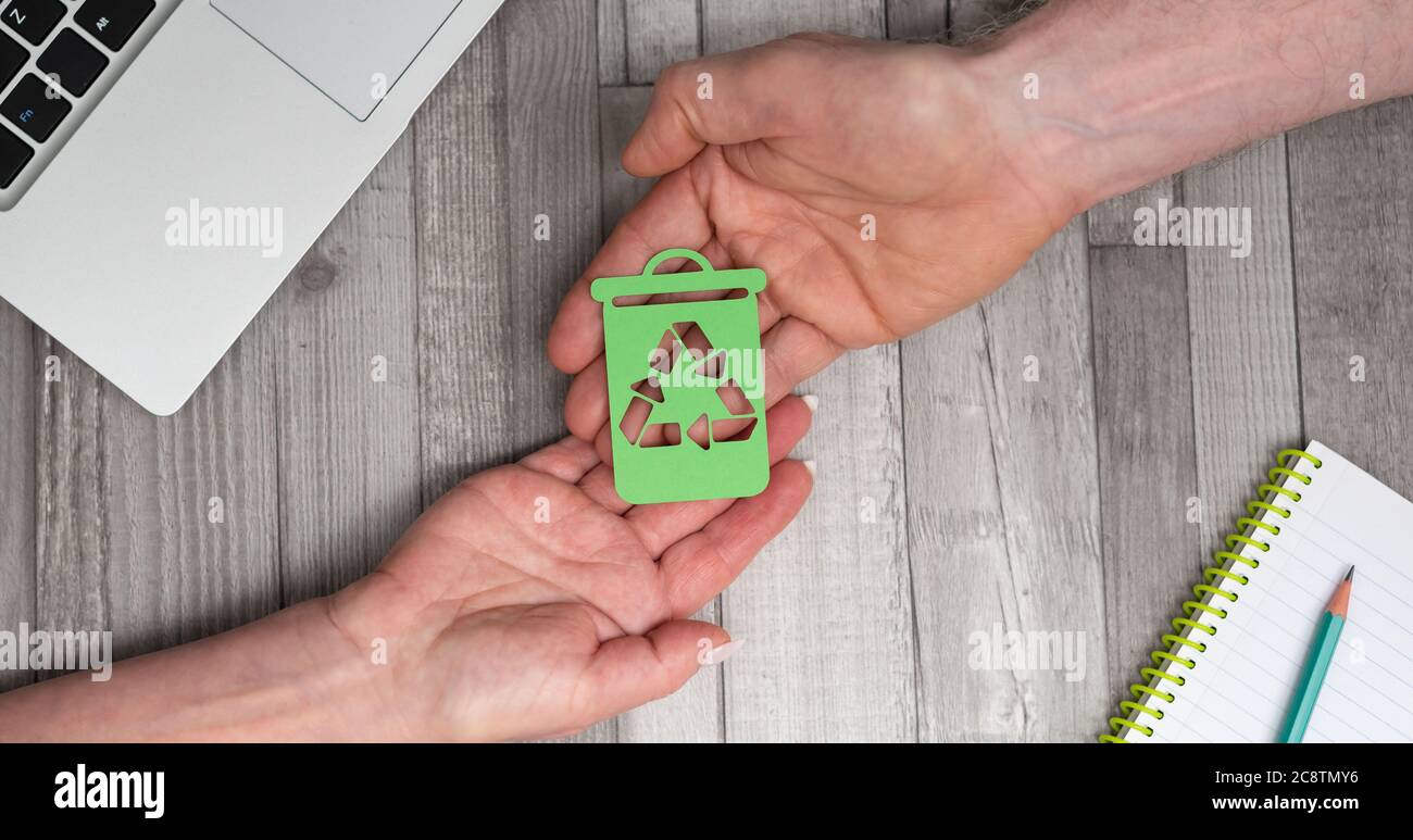 Hands holding a recycling bin; Concept of recycling Stock Photo - Alamy
