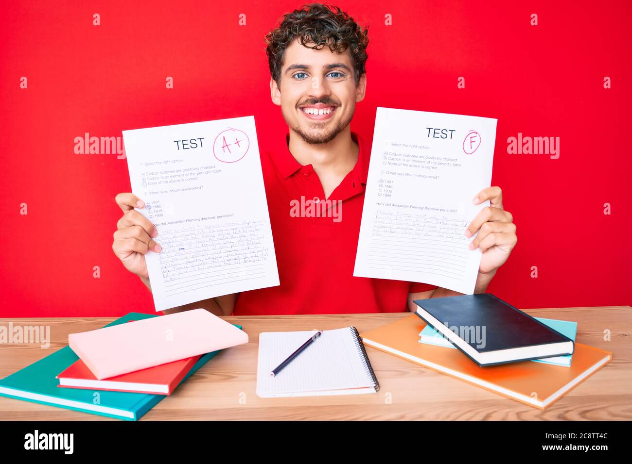 Young caucasian man with curly hair showing a passed exam sitting on ...