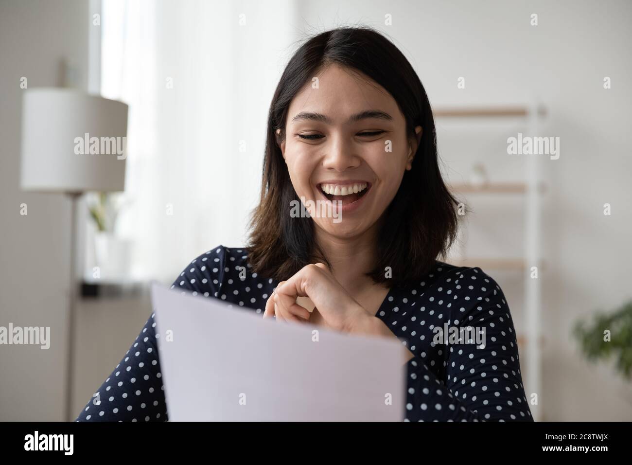 Happy Vietnamese girl smile reading paper letter Stock Photo - Alamy