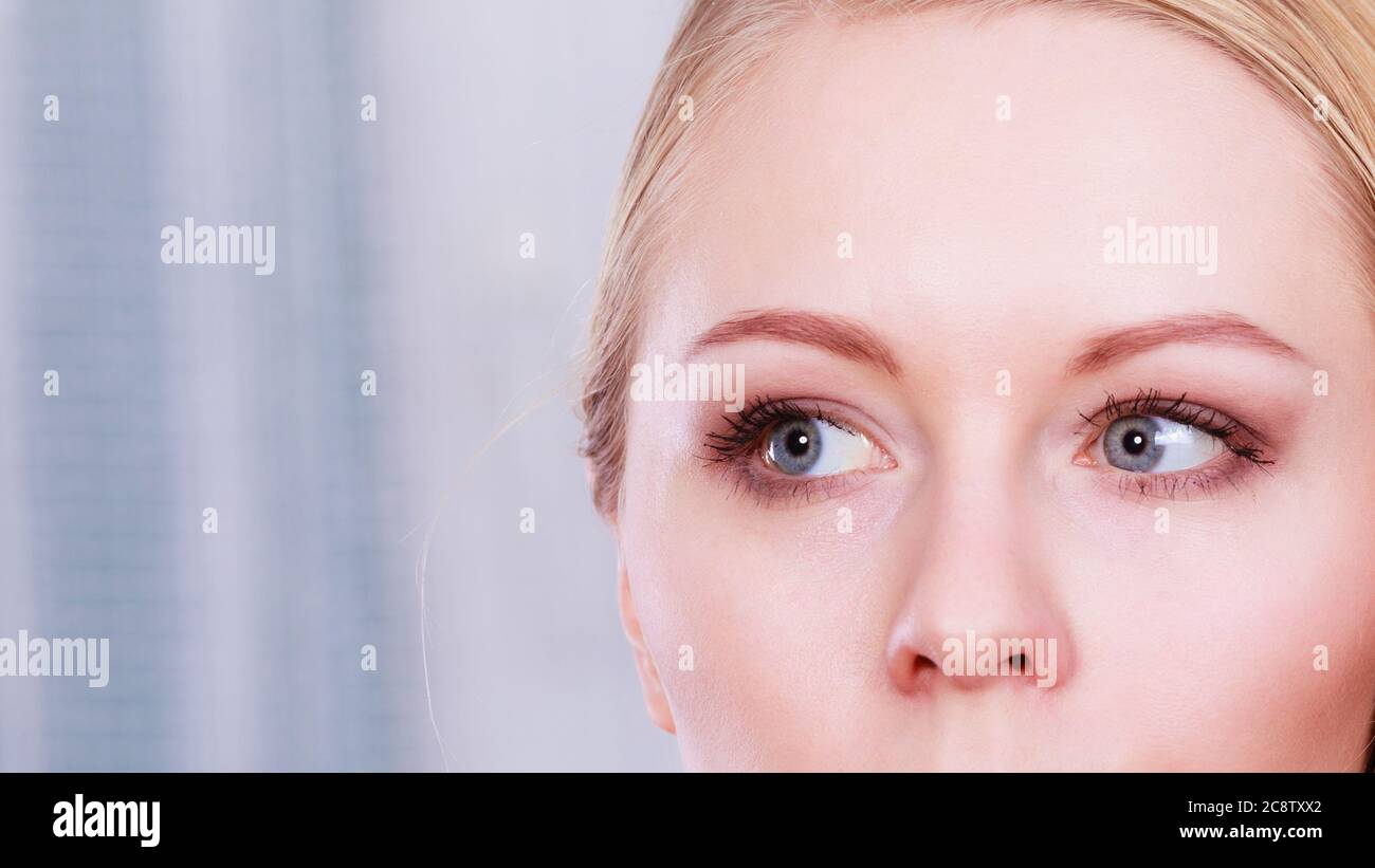 Optics, contact lenses concept. Portrait of blonde woman with grey blue ...