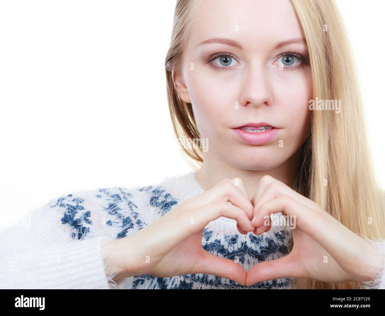 Gestures, signs and symbols concept. Teenage girl making heart sign ...
