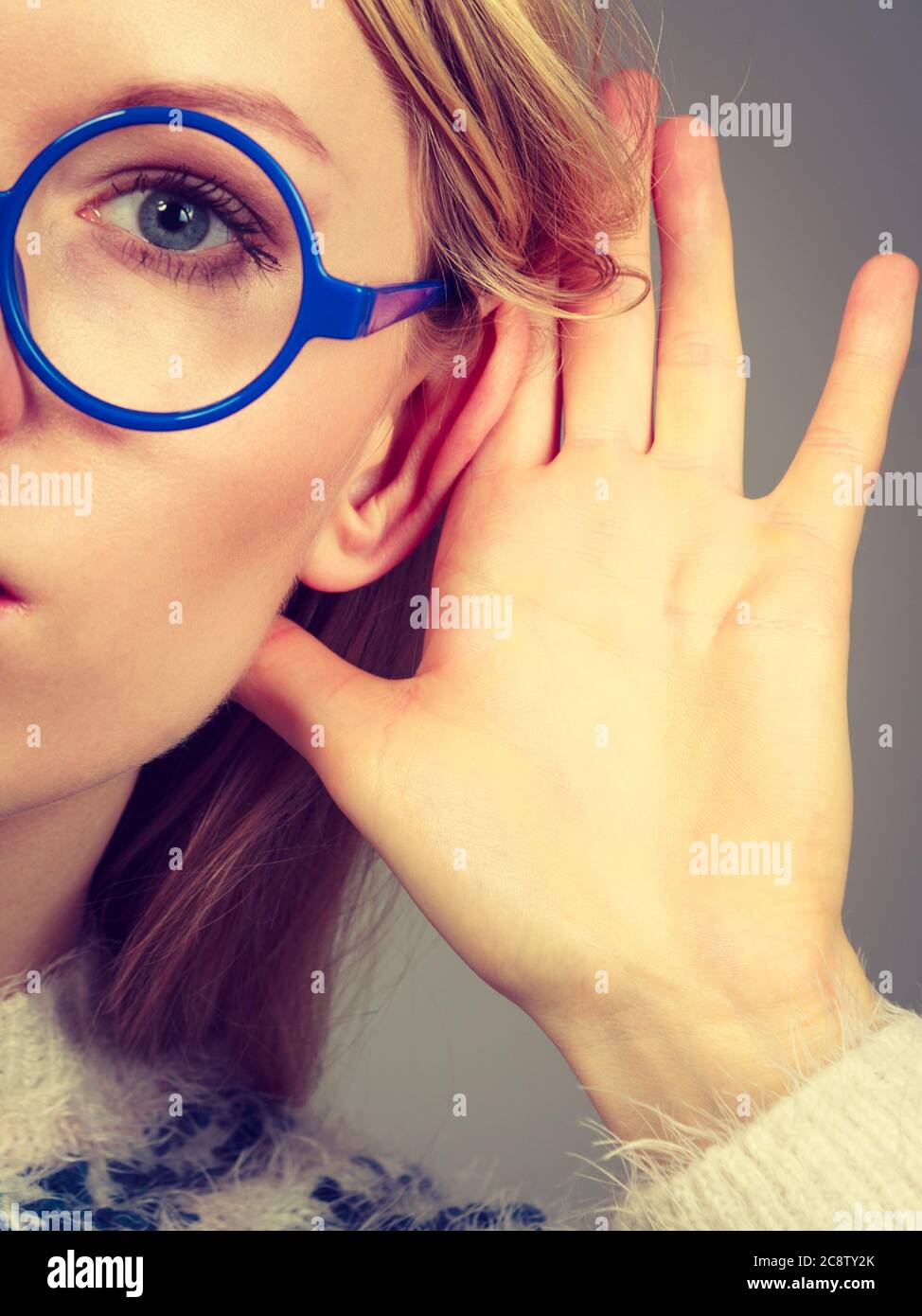 Rumors, gossip and gestures concept. Nerdy blonde woman listening ...