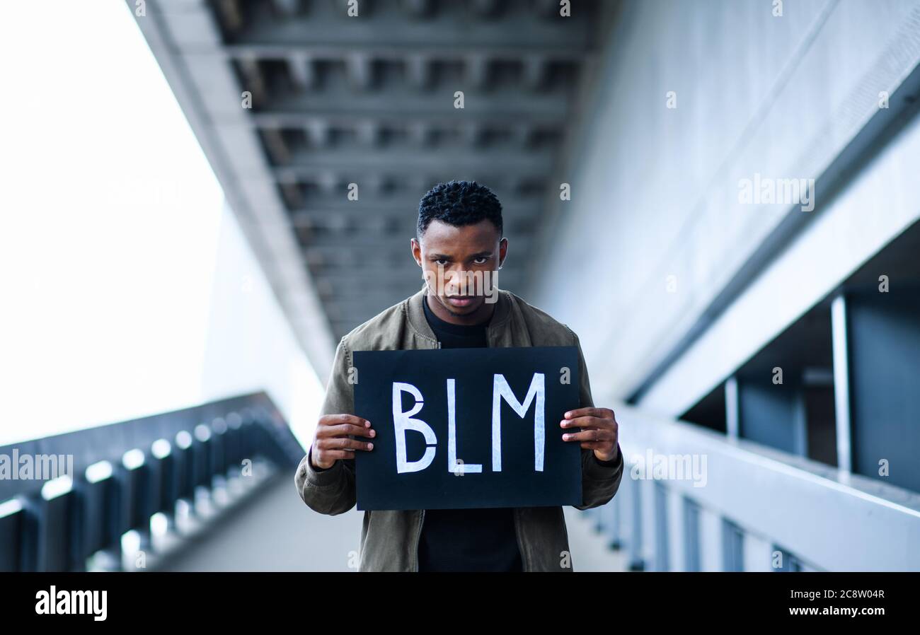 Man with BLM sign standing outdoors, black lives matter concept Stock ...
