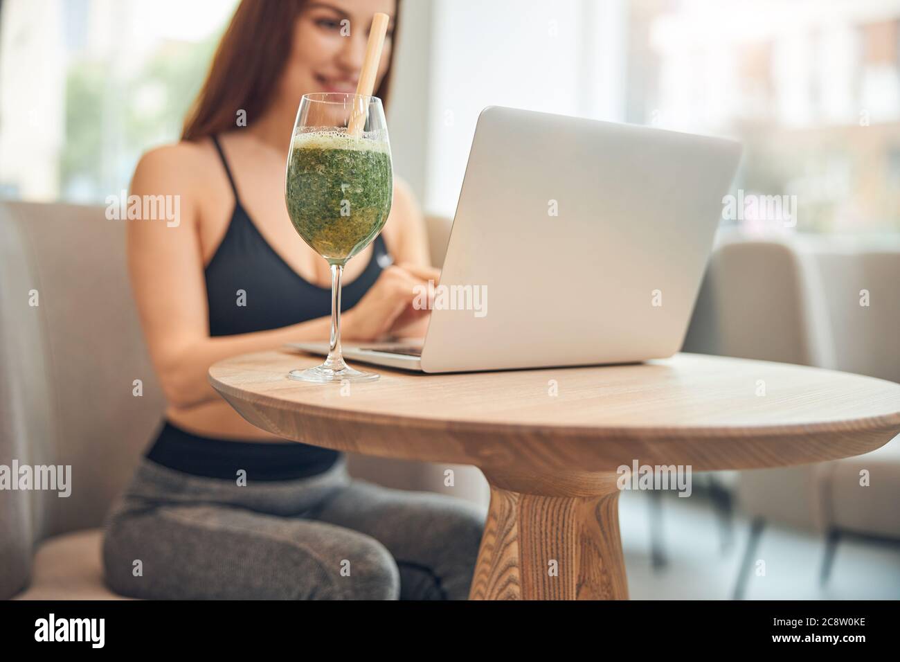Smiling cute lady sitting table hi-res stock photography and images - Alamy