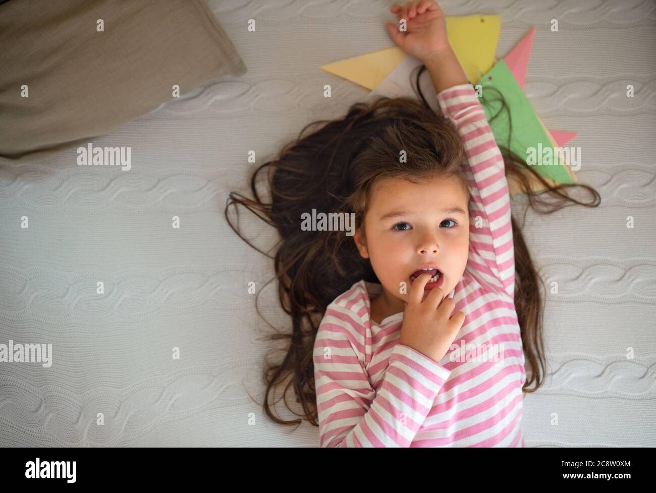 Top view portrait of small girl indoors, looking at camera Stock Photo ...