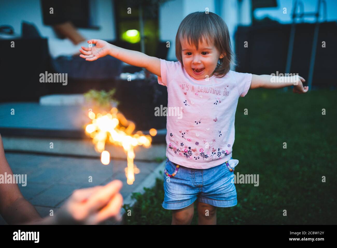 Child seeing sparkler fireworks first time outside Stock Photo - Alamy