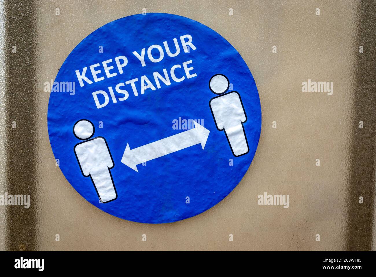 Keep your Distance sticker, stuck to a bus stop shelter Stock Photo - Alamy