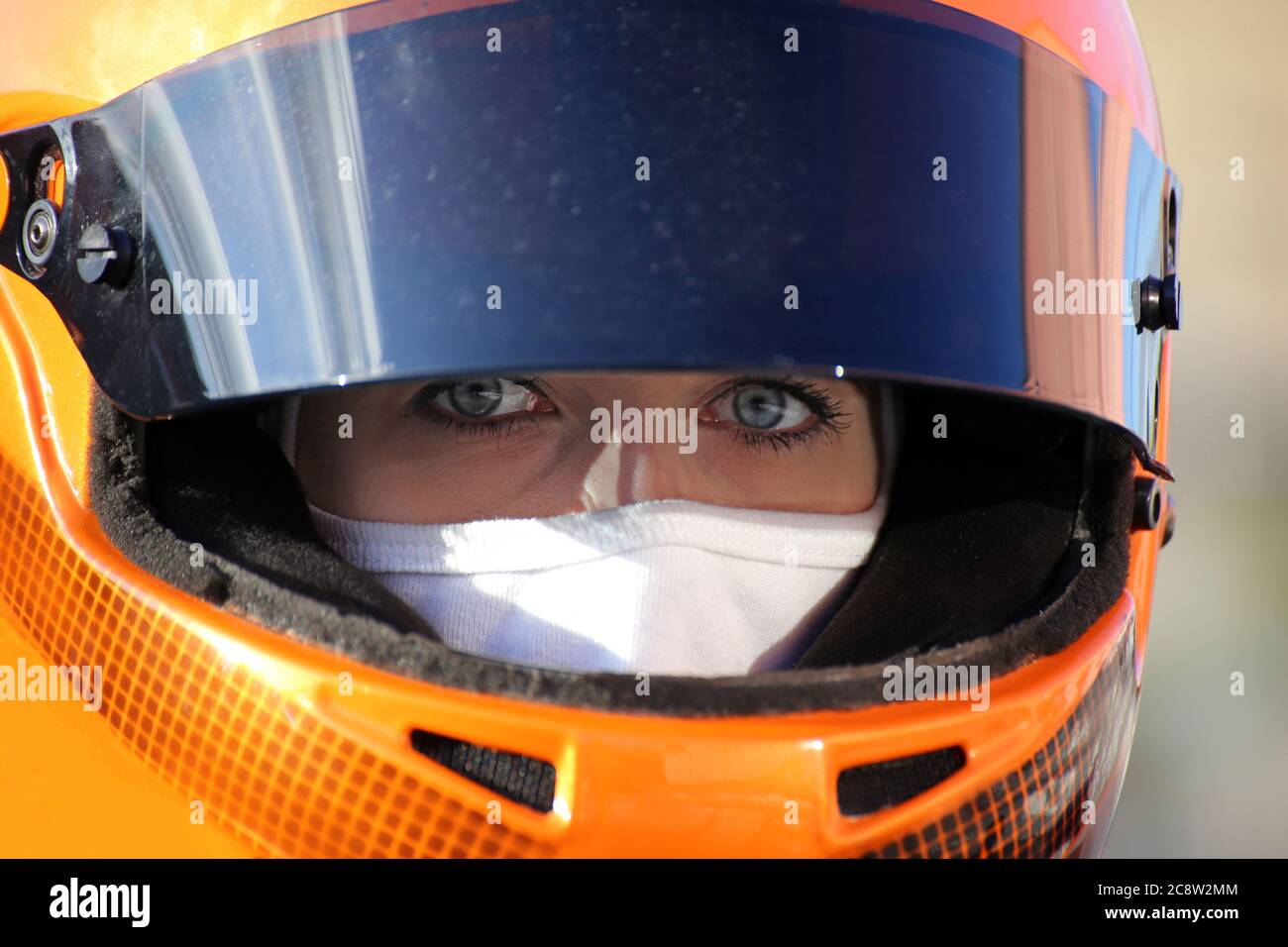 Symbol image: Female race car driver wears helmet and balaclava (Model ...