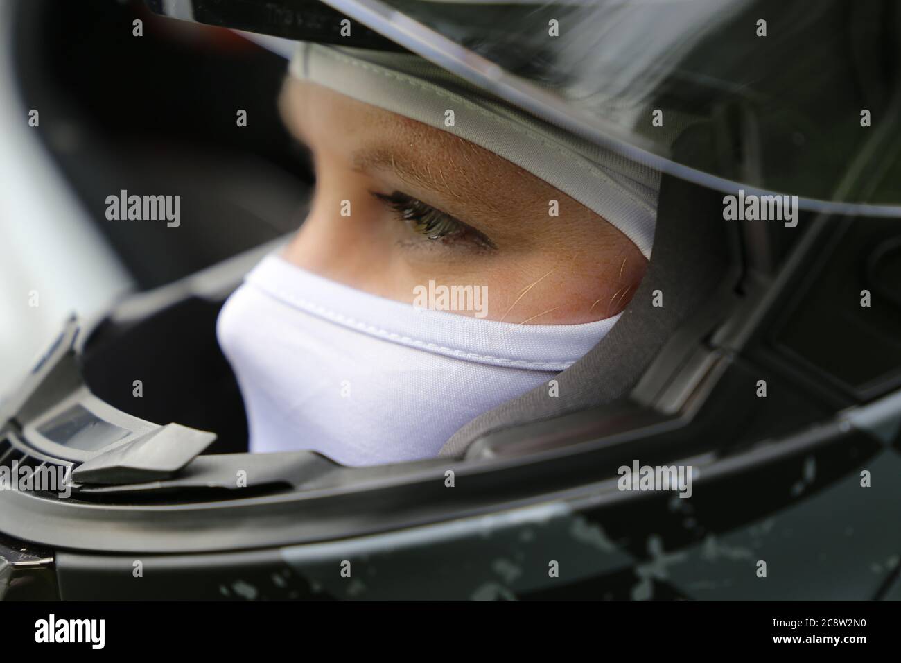 Symbol image: Female race car driver wears helmet and balaclava (Model ...