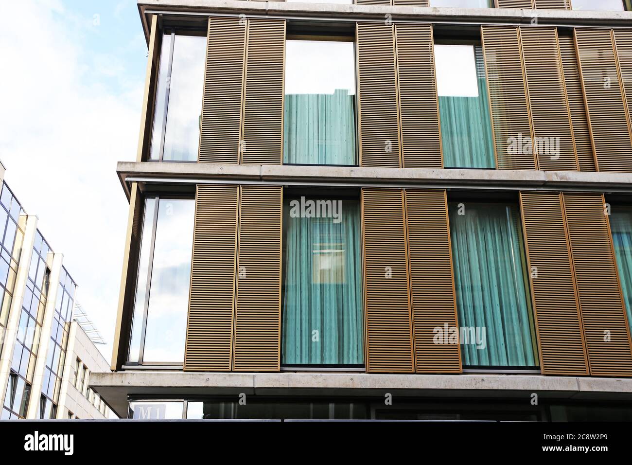Urban building with modern wooden sliding shutters Stock Photo - Alamy