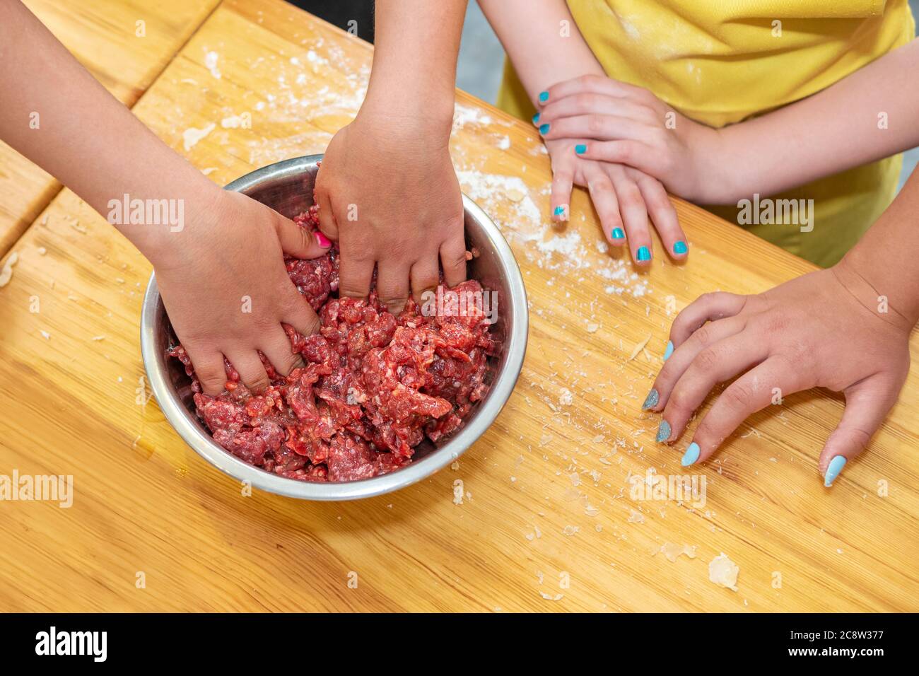 children hands mix minced meat in a bowl on a wooden table Stock Photo ...