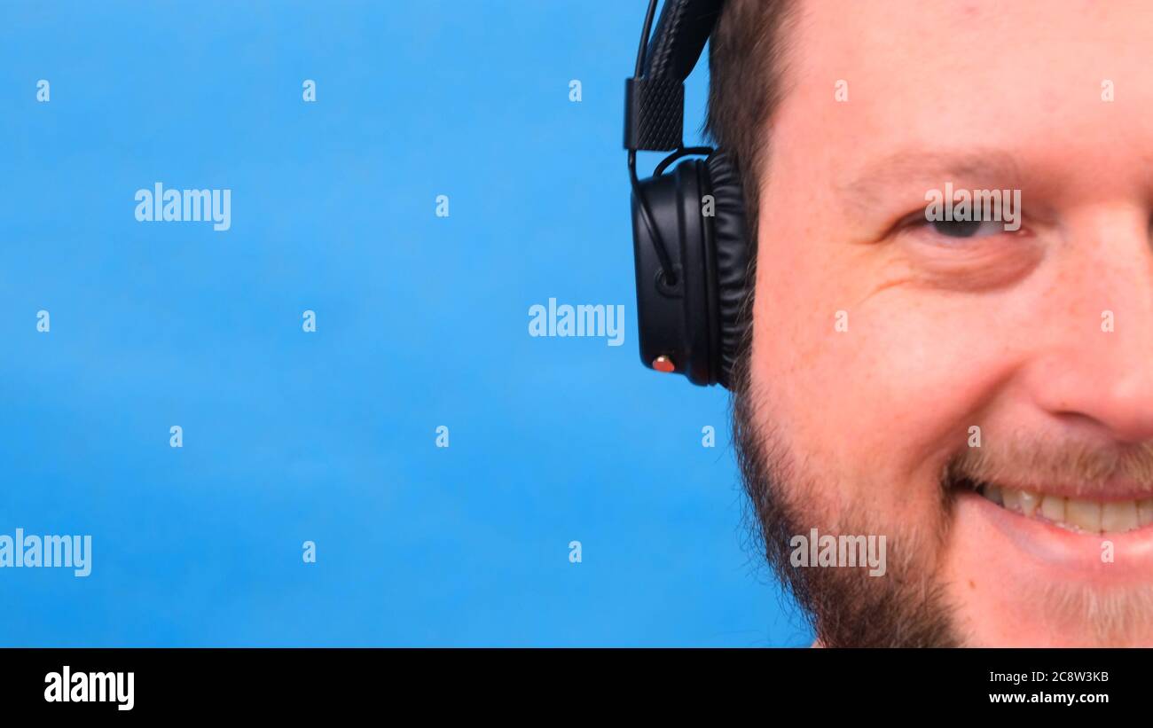 Cheerful charismatic fat man in headphones isolated and pink t-shirt on ...