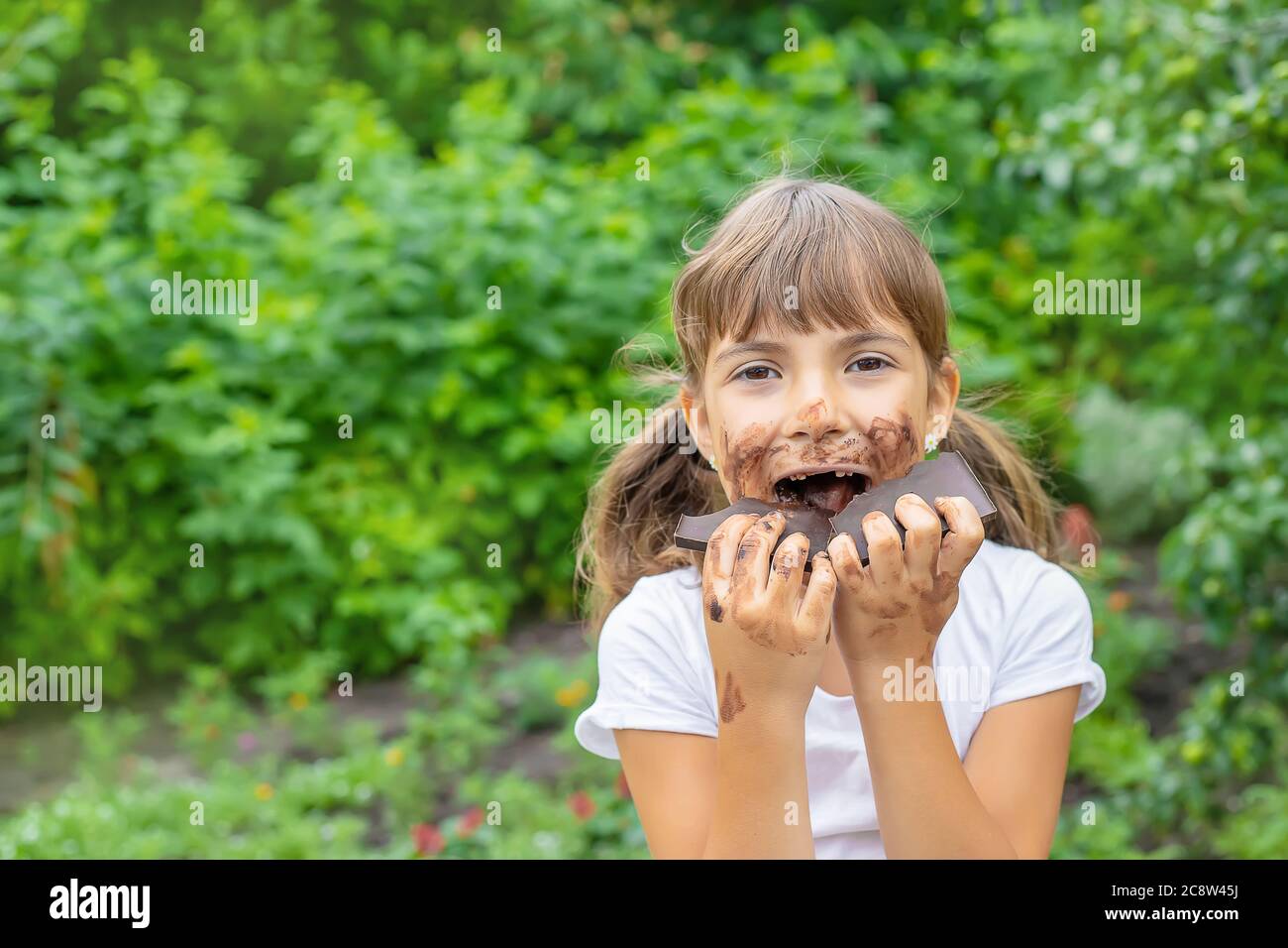 The child eats a chocolate bar. Selective focus. People Stock Photo - Alamy