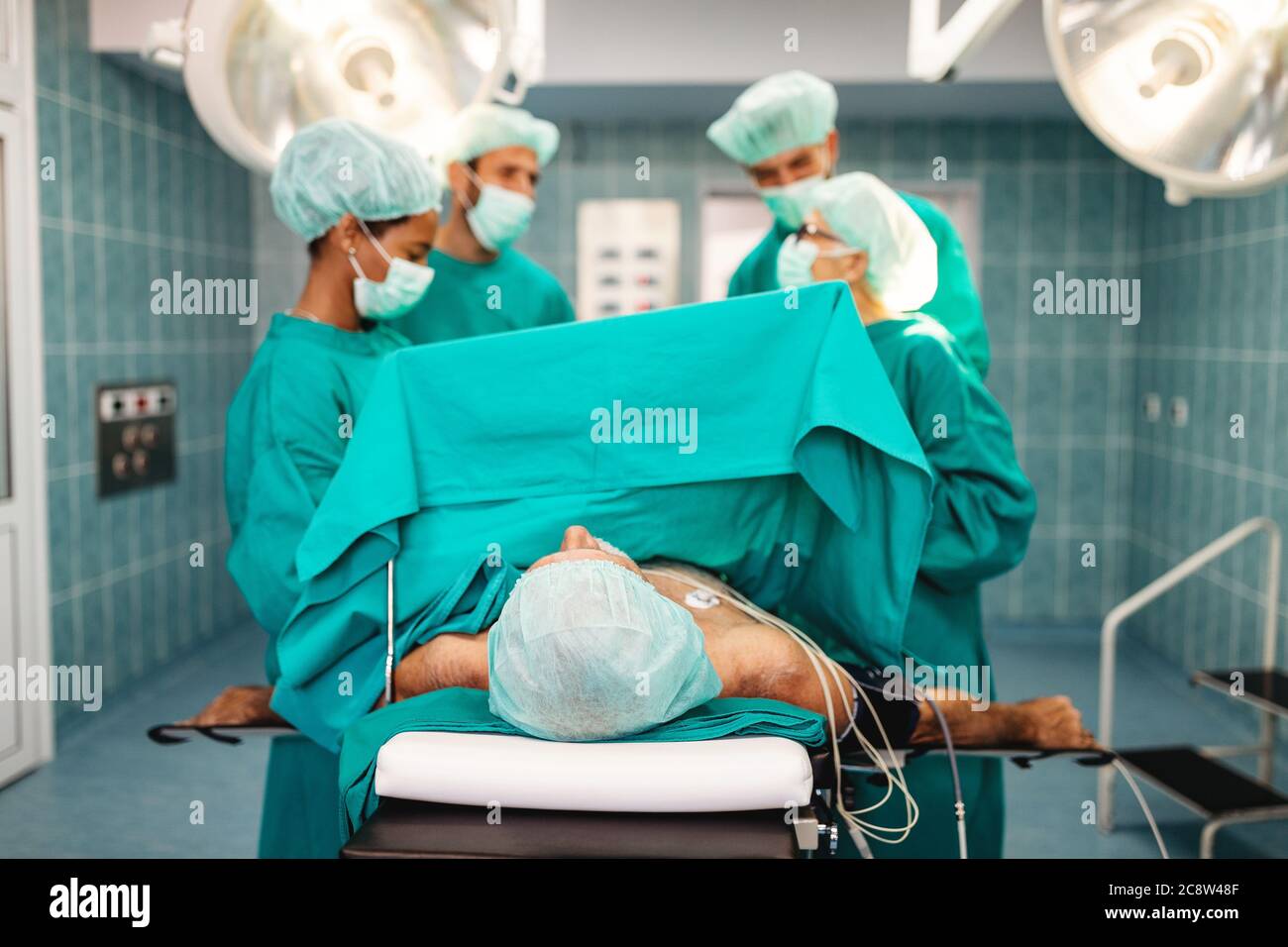 Surgery team operating in a surgical room Stock Photo - Alamy