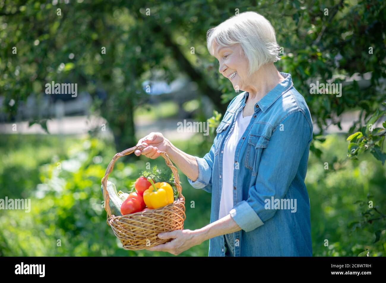 Elderly woman enjoying fresh and ripe vegetables Stock Photo - Alamy