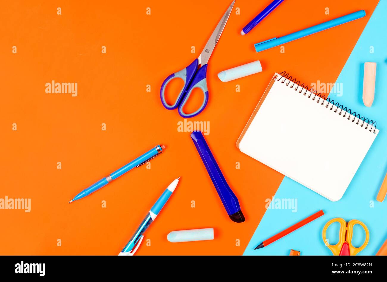 School supplies on blue and orange background. Education concept Stock ...
