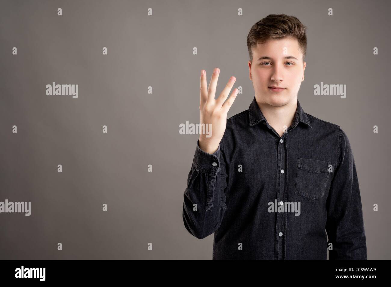 Portrait of serious stylish attractive man dressed with a casual black ...