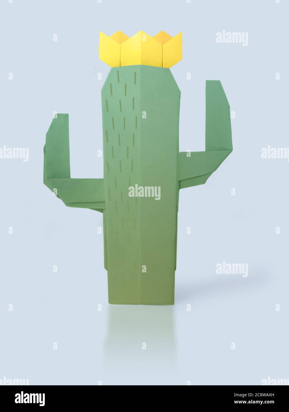 Origami succulent cactus with yellow flowers on a pale blue background ...