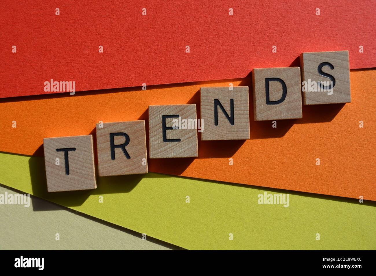 Trends, word in wooden block letters on multicoloured background Stock ...