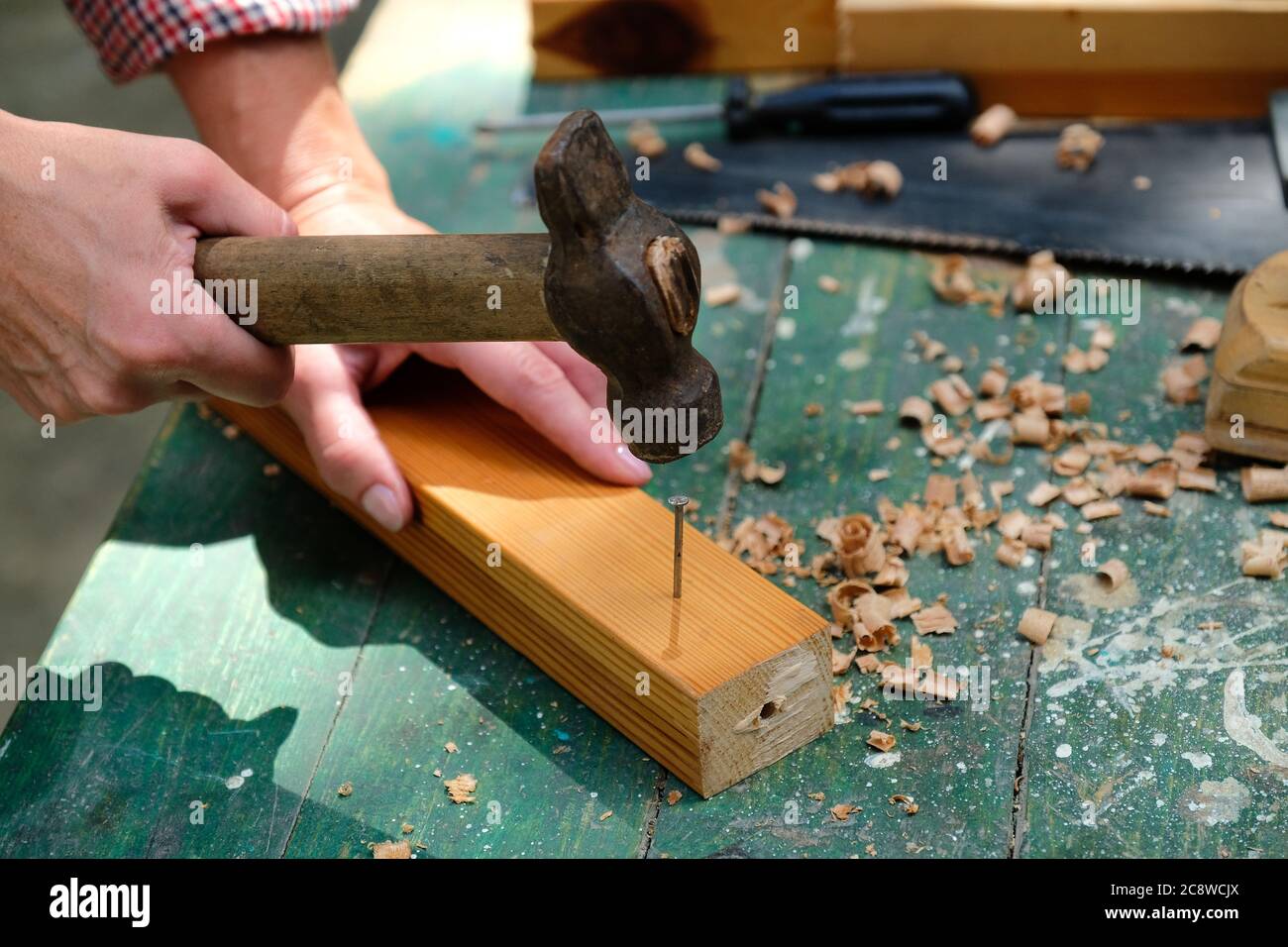 Carpenter with hammer hitting nails.Woodwork concept Stock Photo - Alamy