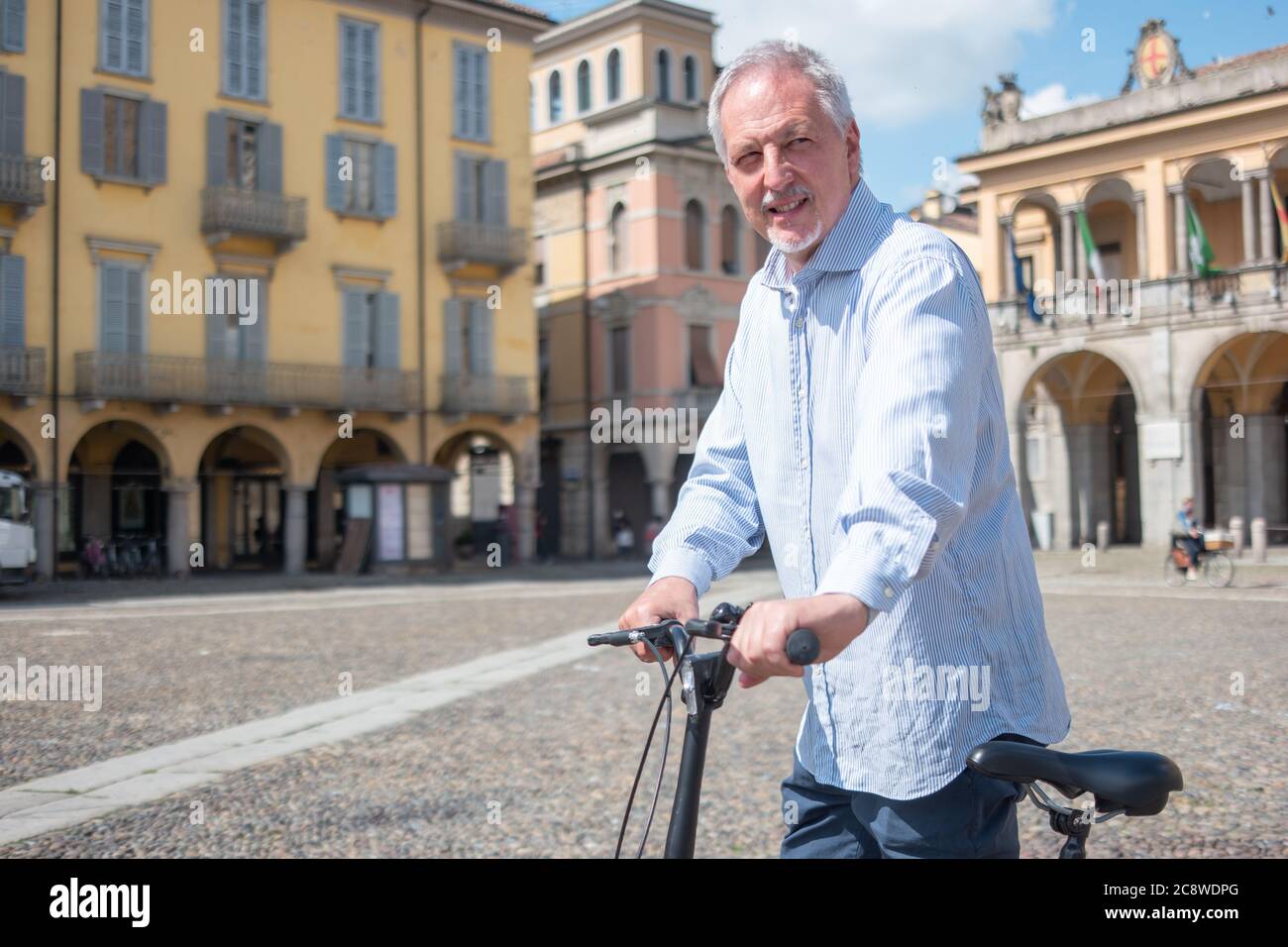 Man riding his bike in a city square Stock Photo - Alamy