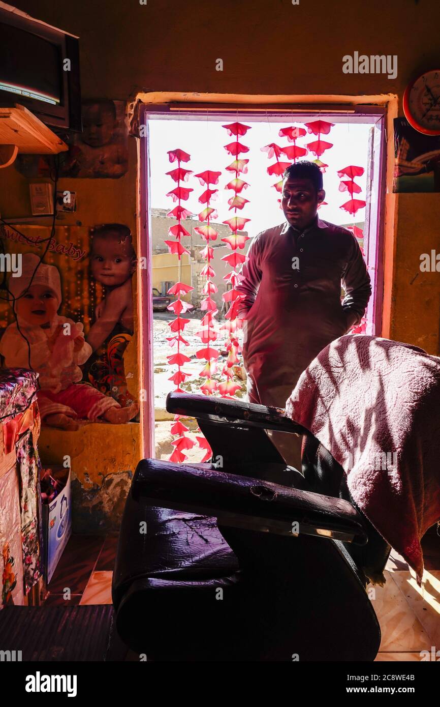 Siwa Oasis, Egypt The interior of a small barber shop and patron ...