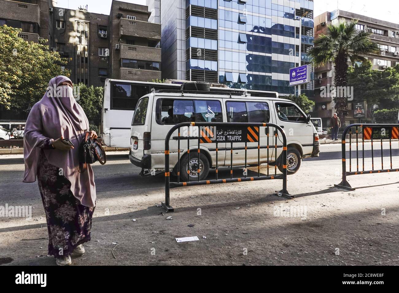 Cairo, Egypt An Arab woman in a veil walks on a busy street in the ...