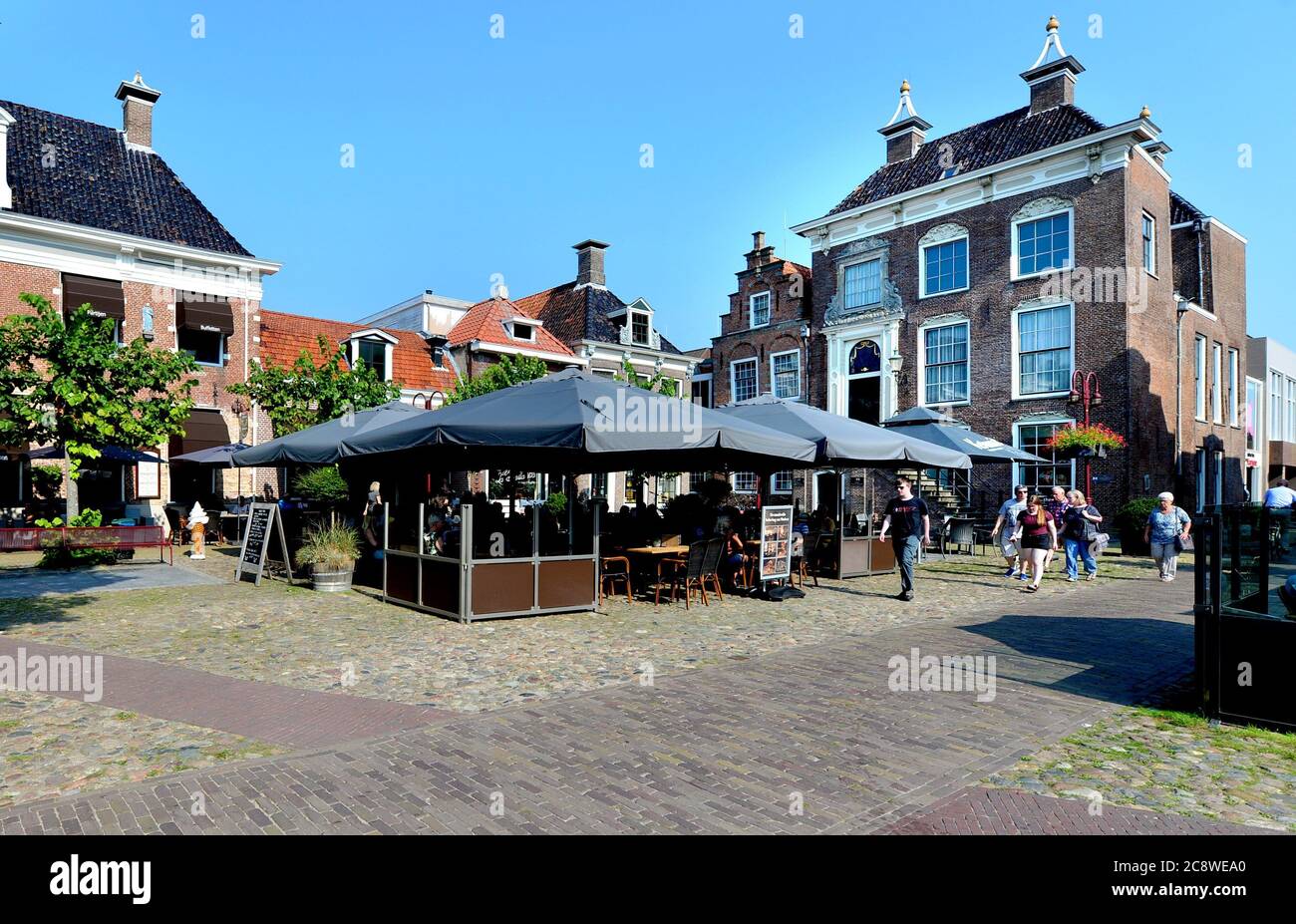 Seats and parasols of restaurants at the town center of Workum ...