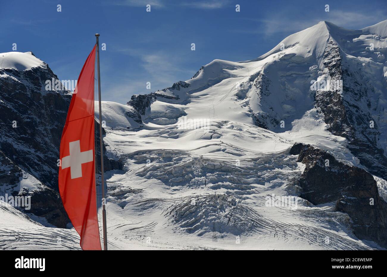 A Swiss flagg on Diavolezza mountain with view on Persch glacier ...