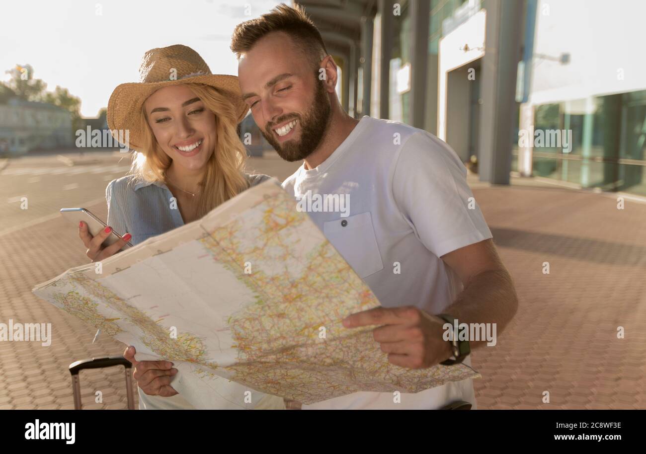 Tourists looking at the map and mobile phone Stock Photo - Alamy