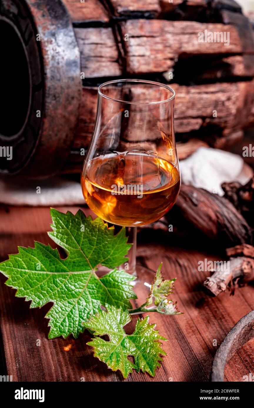 Tasting glasses with aged french cognac brandy in old cellars of cognac ...