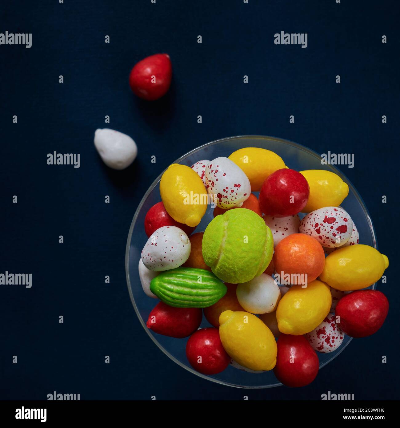 Colorful chewing gum of different shapes on blue background, shallow ...