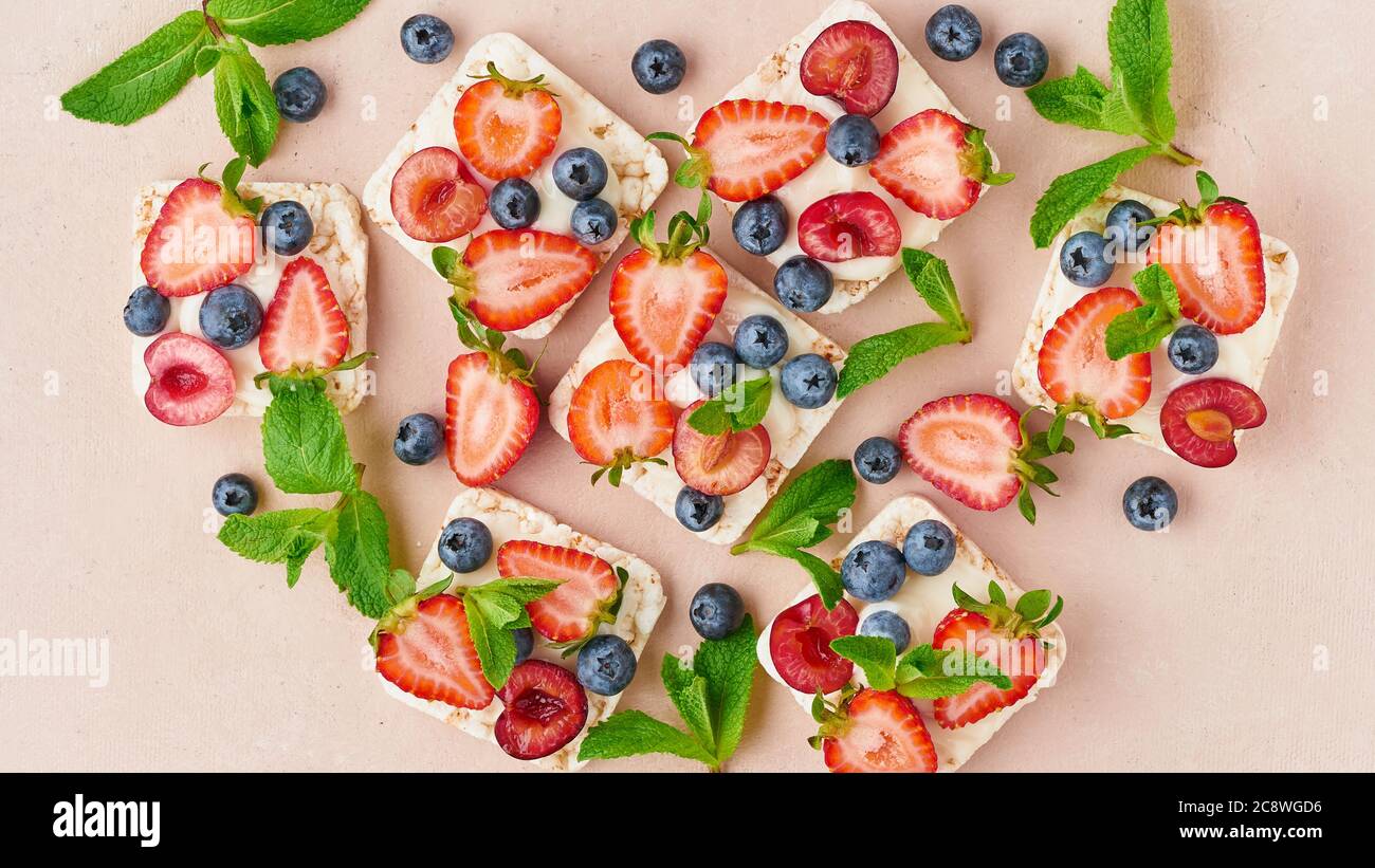 Rise crispbread with berries and fruits colorful concept on terracotta ...
