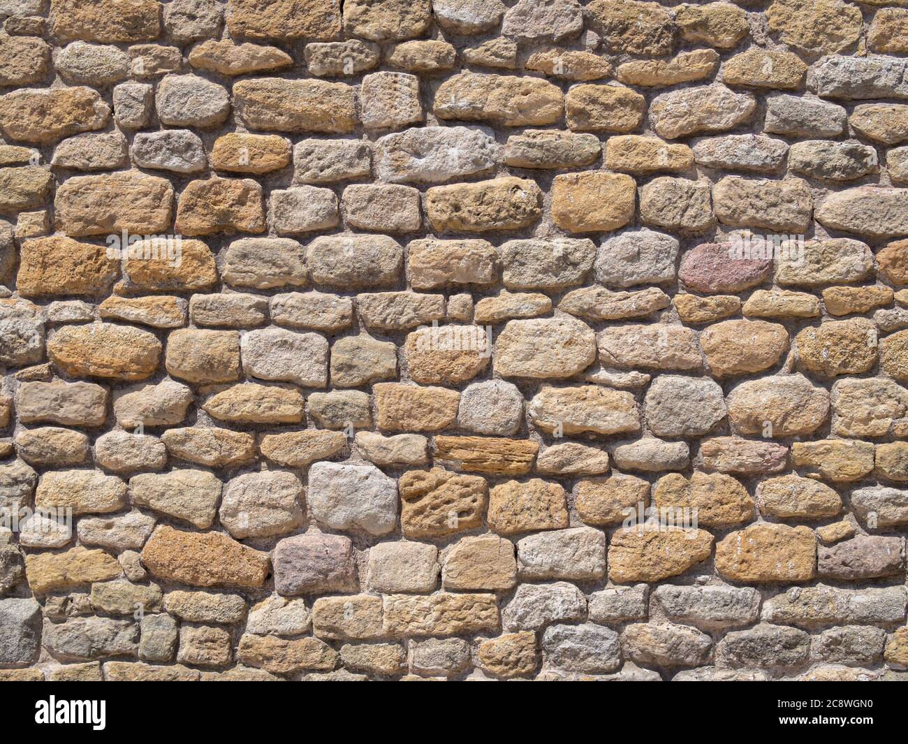 Real antique spanish rubble wall background texture Stock Photo - Alamy