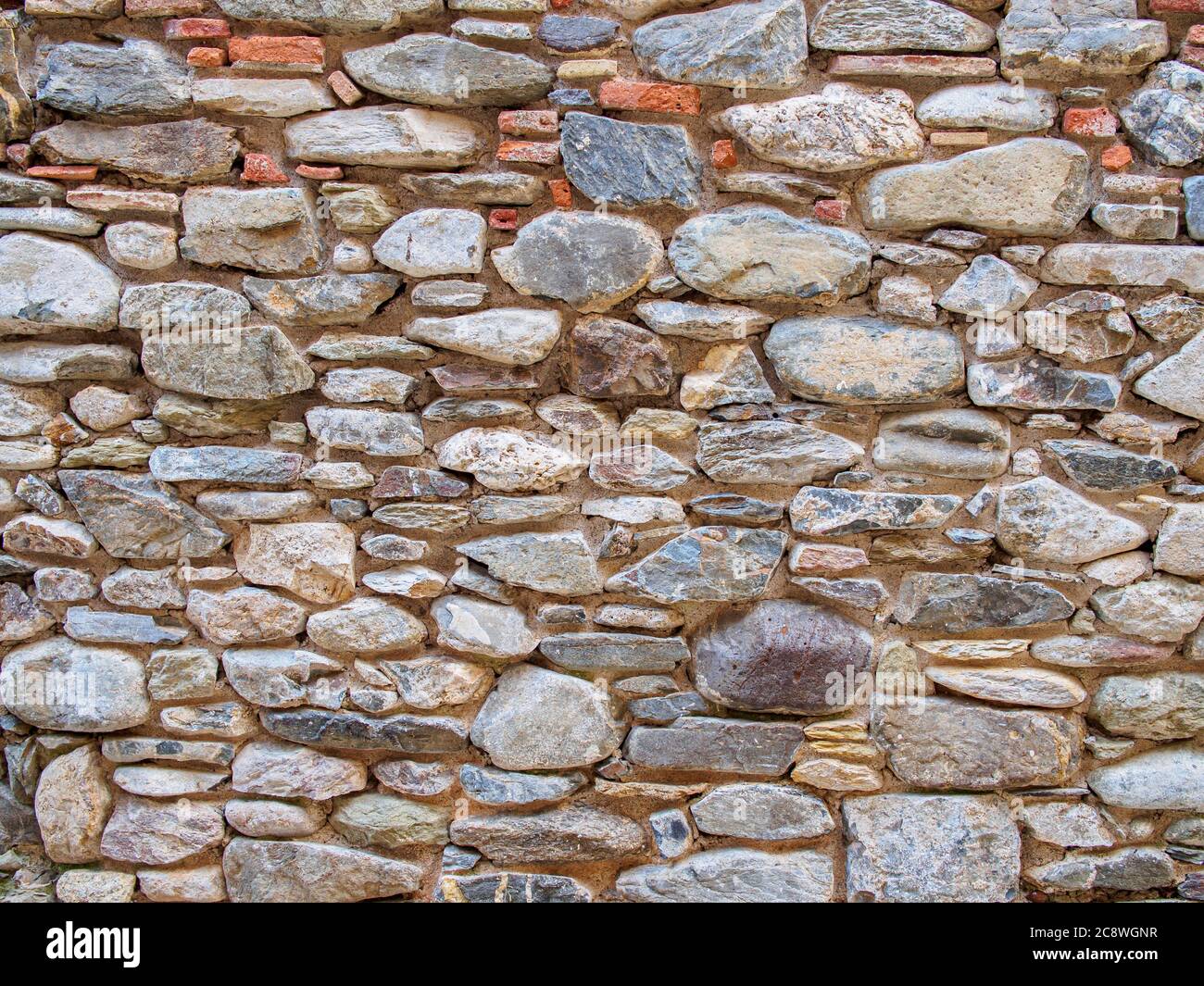 Real antique spanish rubble wall background texture Stock Photo - Alamy