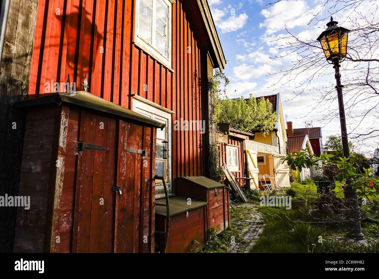 Kalmar, Sweden The grassy backyard to a red wooden house in the old ...