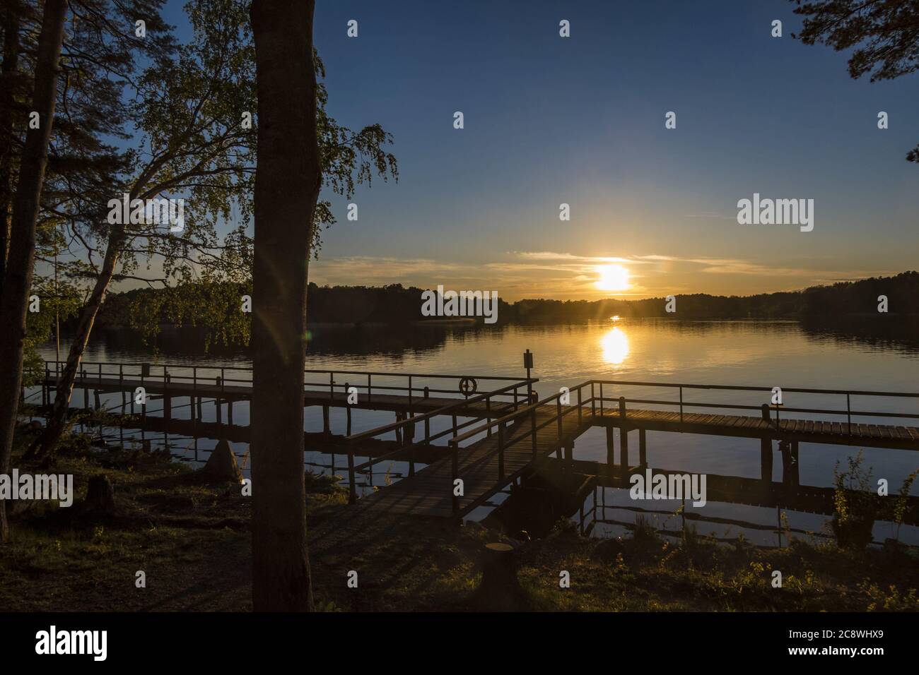 Stockholm, Sweden The suns sets over a dock on Lake Malaren. | usage ...