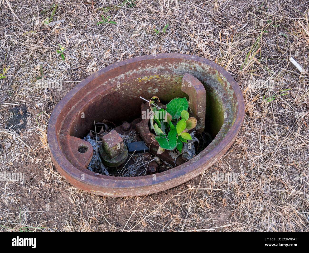 Old rusty gas cap in the ground, without lid Stock Photo - Alamy