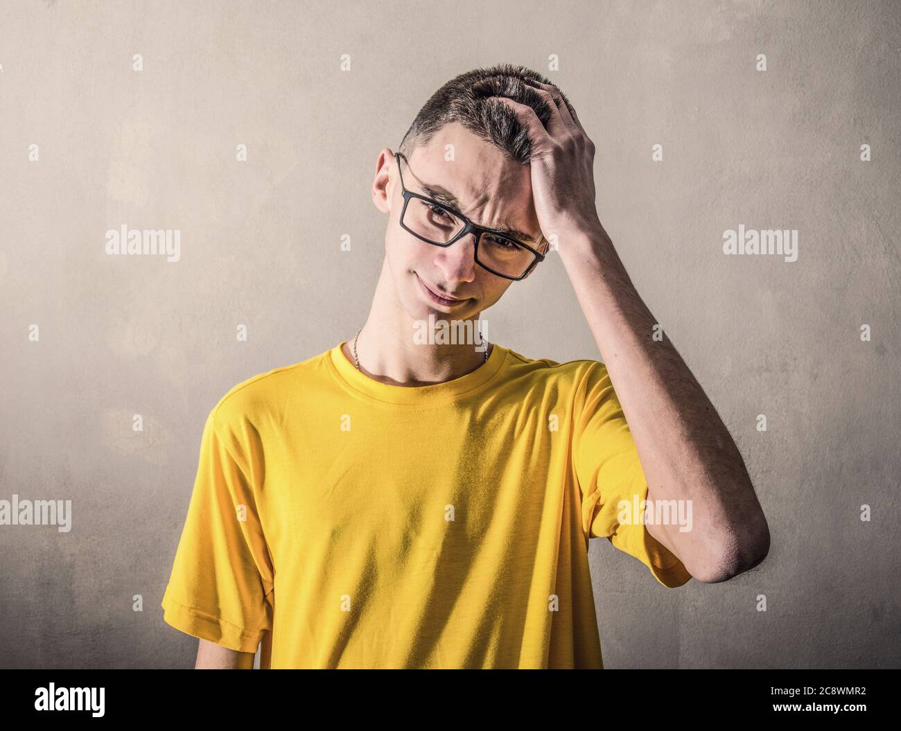 a Boy with yellow T-shirt and worried expression Stock Photo - Alamy