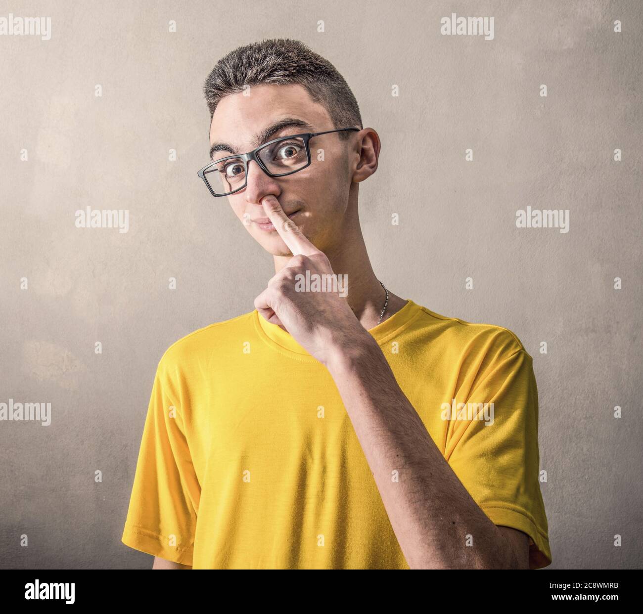 a Boy with yellow T-shirt and funny expression Stock Photo - Alamy