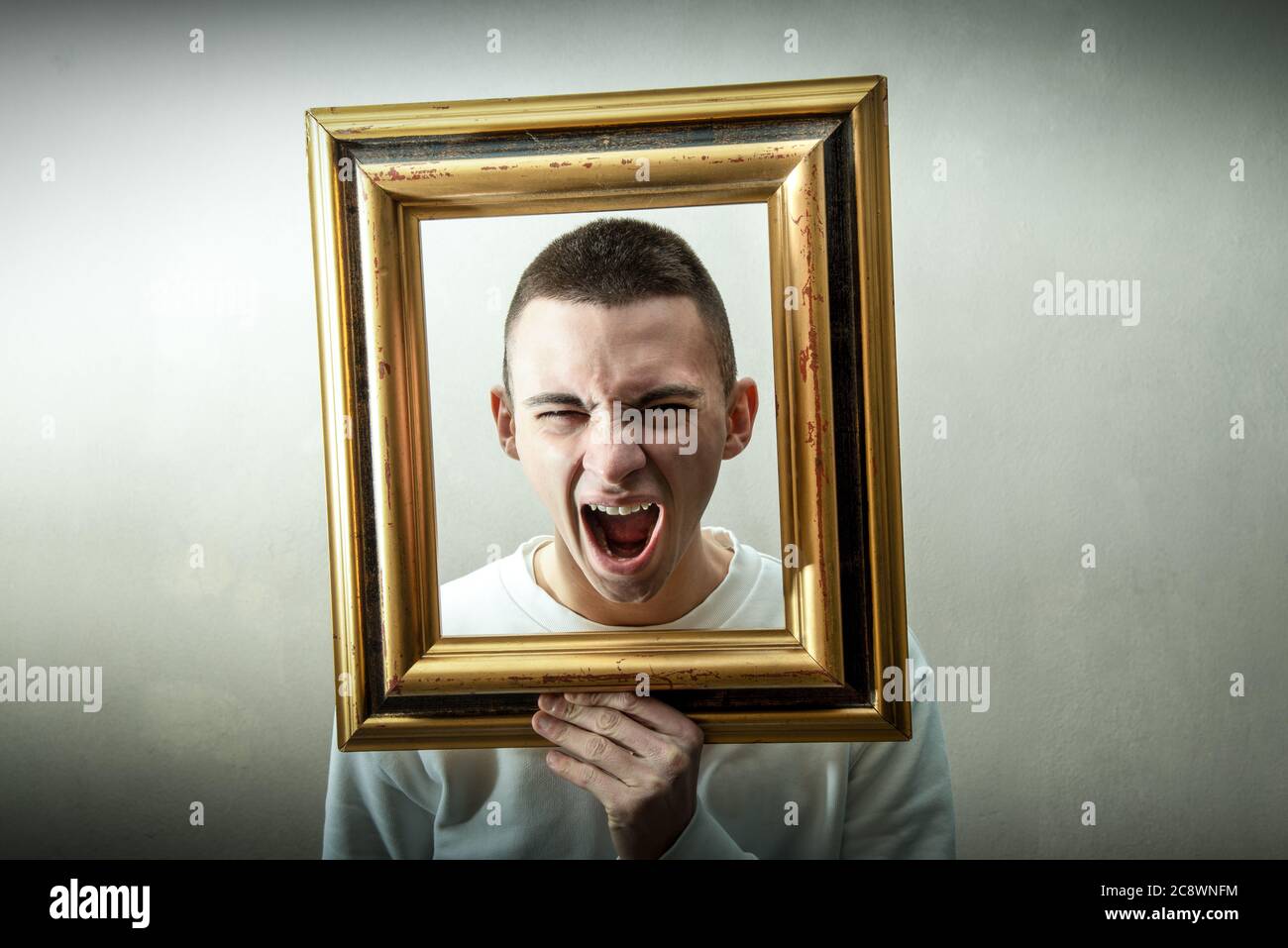 a boy screaming with a frame around his face Stock Photo - Alamy