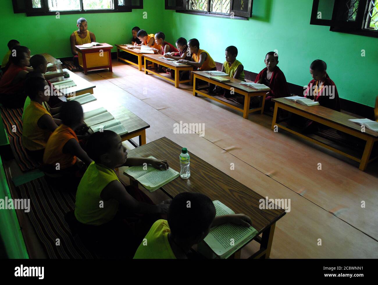 The Buddhist children are reading book in their classroom at Sarnath ...