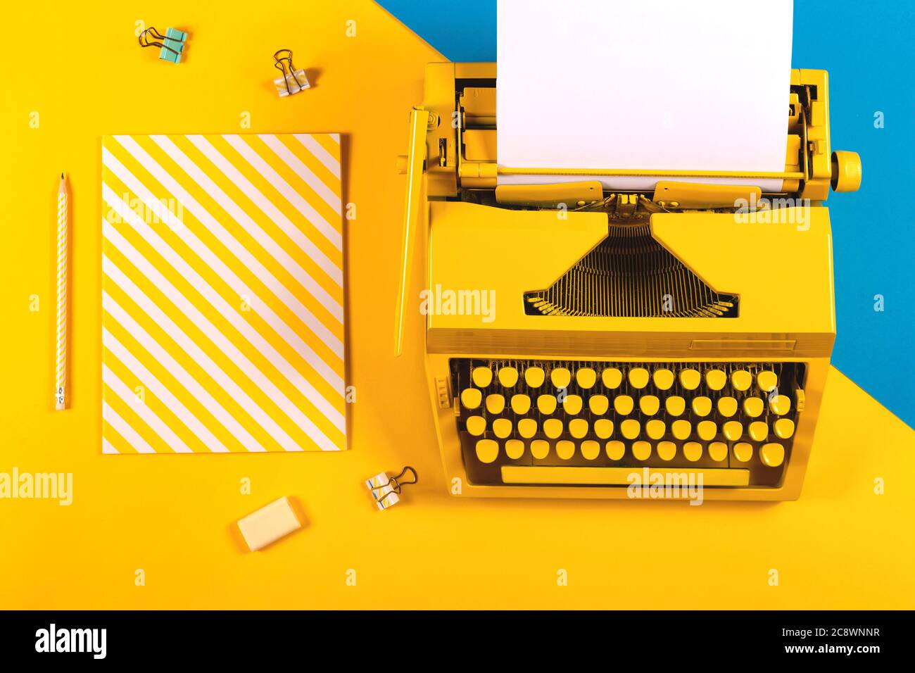 Yellow bright typewriter on a yellow background. Creativity concept ...