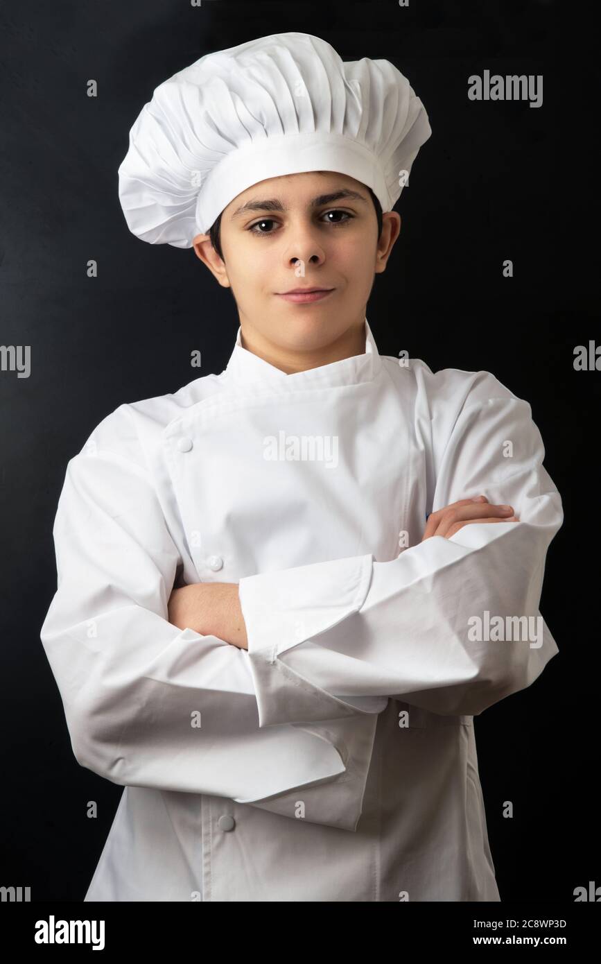 young smiling chef on dark background Stock Photo - Alamy