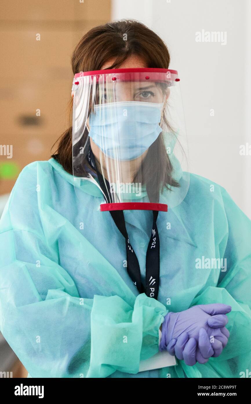 Dressed in protective clothing, a employee of a blood donation station ...