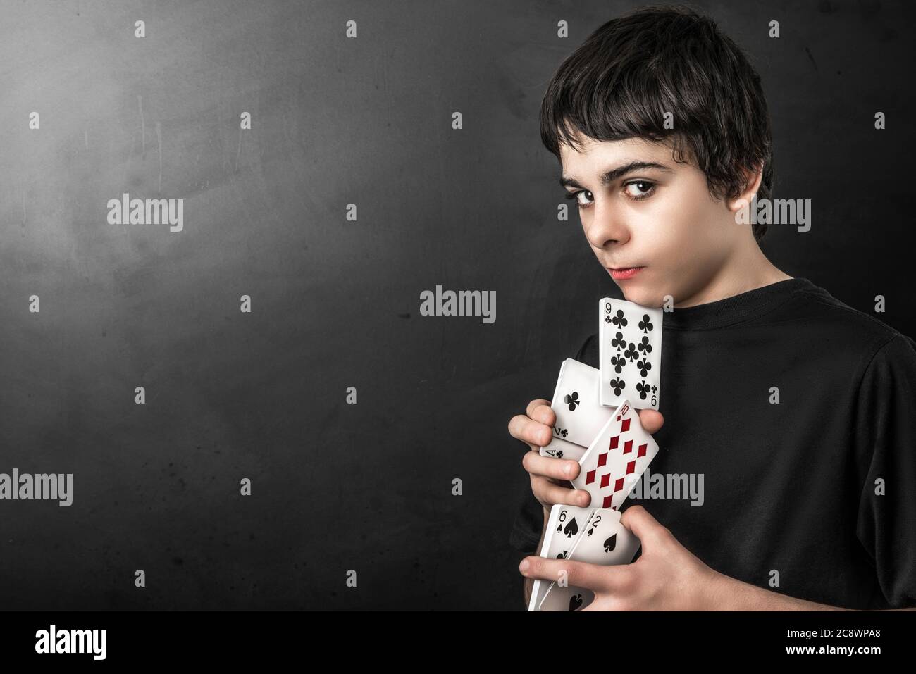 Young magician with playing cards Stock Photo - Alamy